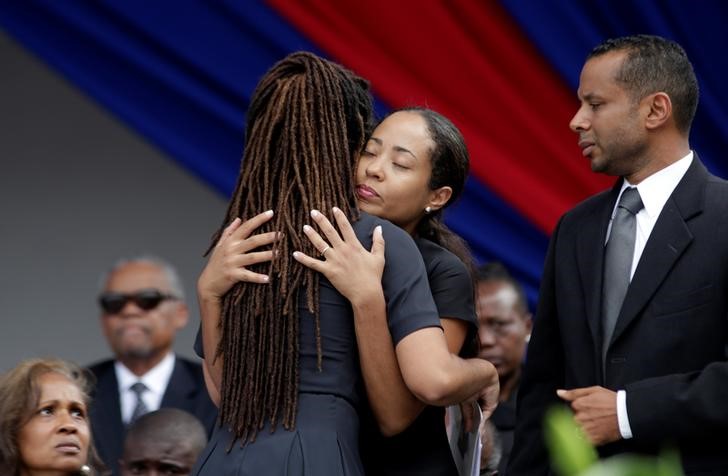 Dominique embraces her sister Patricia, daughters of Haiti’s former ...